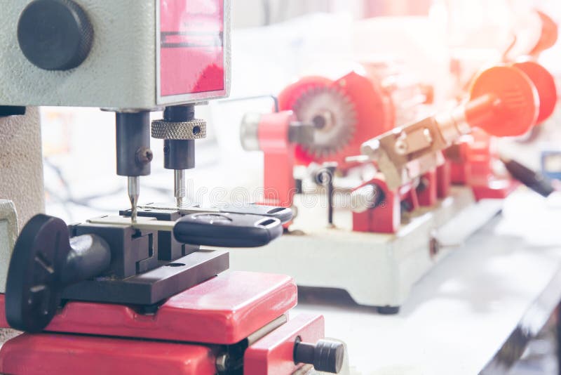 Locksmith in Workshop Makes New Key. Professional Making Key in ...