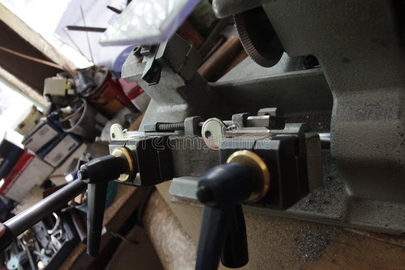 Locksmith in Workshop Makes New Key. Professional Making Key in ...