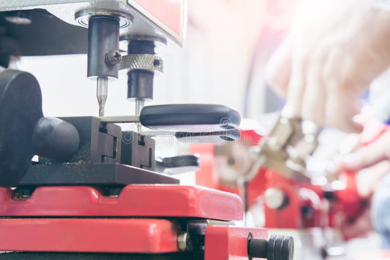 Locksmith in Workshop Makes New Key. Professional Making Key in ...