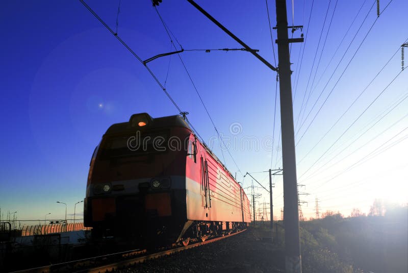 The Locomotive of a Freight Train Carrying Goods. at Sunset. Stock ...