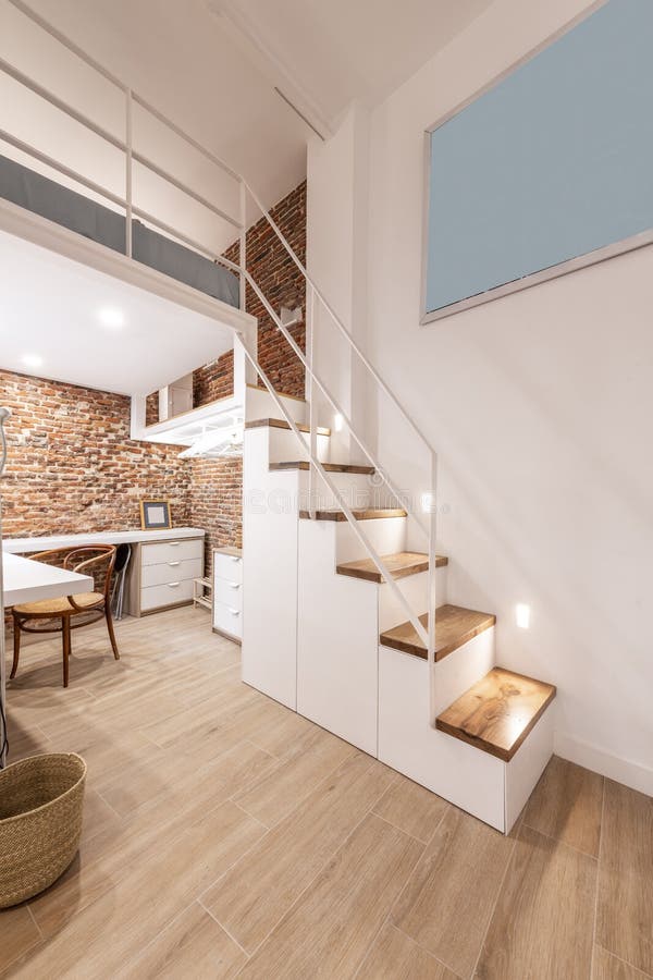 Loft Apartment with a Staircase with Wooden Steps and Cabinets with ...