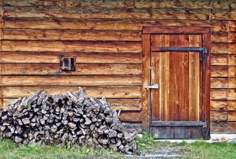 Log Cabin Wall with Small Window, Door and Wood Stack Stock Photo ...