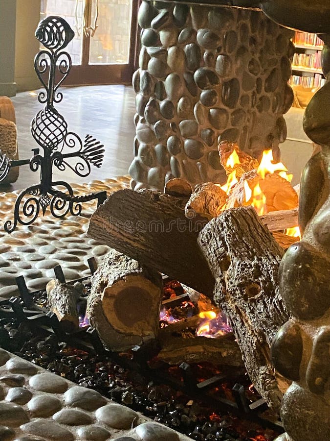 Log Fire in Large Polished Pebble Open Fireplace with Black Scrolled ...