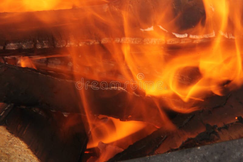 Log in the Flames. Burning Fire in the Grill is Large. Stock Photo ...
