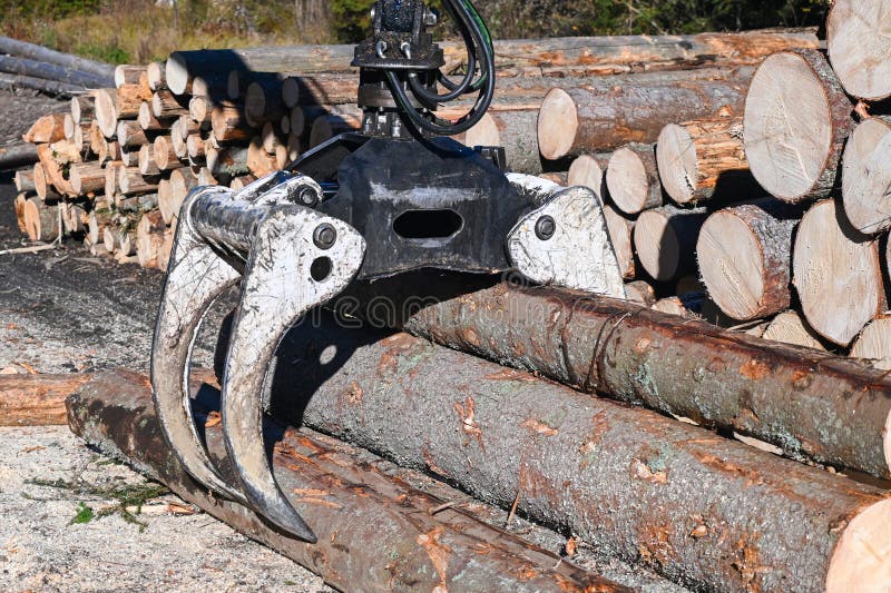 A Log Grabber Comes into Action Stock Photo - Image of logs ...