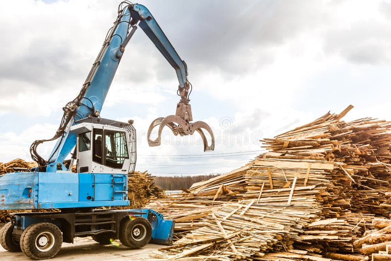 Log Loader or Forestry Machine Loads a Log Truck Stock Photo - Image of ...
