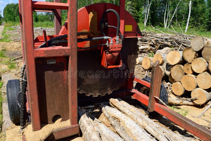 Log Slasher with Freshly Cut and Piled Wood Stock Photo - Image of ...