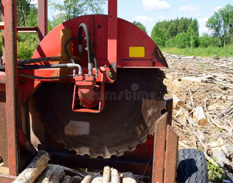 Log Slasher Saw with Tops and Limbs in Background Stock Image - Image ...