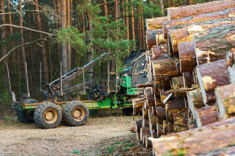 Loading Logs on a Truck Trailer Using a Tractor Loader with a Grab ...