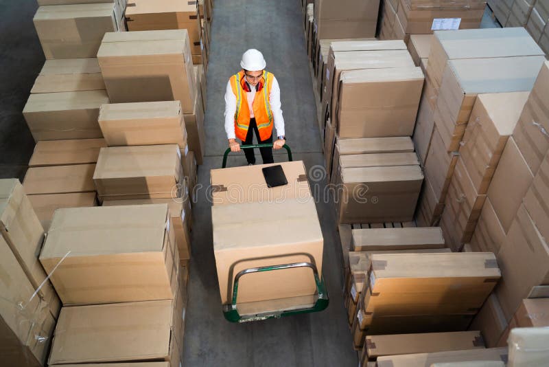 Logistic Warehouse Worker Delivering Boxes on a Trolley. Stock Photo ...