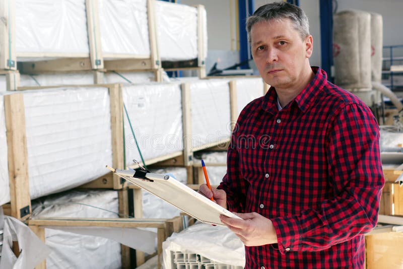Man with Folder Management in the Hands of the Warehouse . Logistics ...