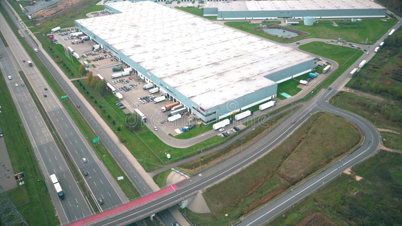 Logistics Park with a Warehouse - Loading Hub. Semi-trucks with Freight Trailers Standing at the ...