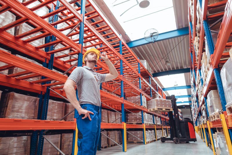 Logistics Worker Standing in High Bay Warehouse Stock Photo - Image of ...