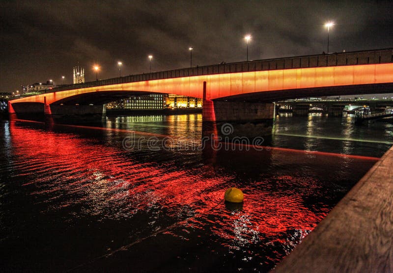 London Bridge at Night with the Reflection of Red Light in the River ...