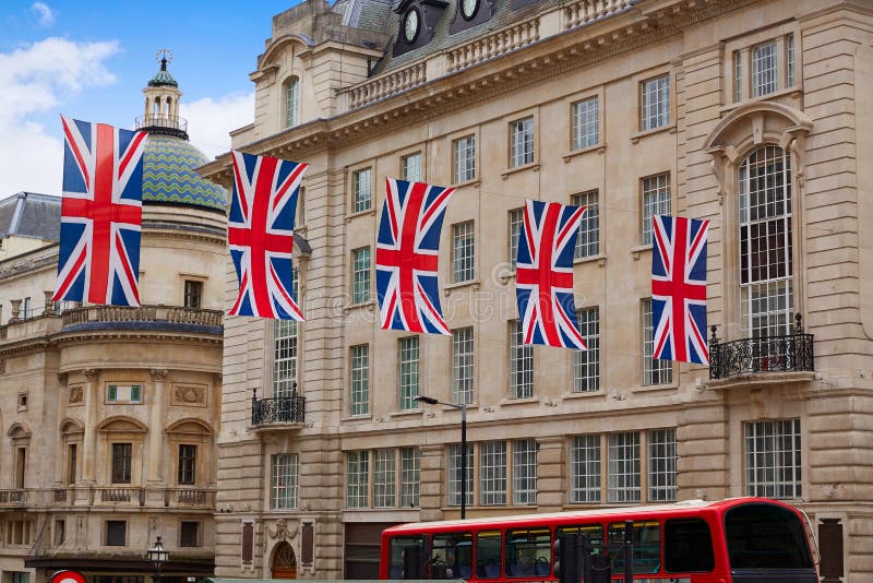 London Bus and UK Flags in Piccadilly Circus Stock Photo - Image of ...