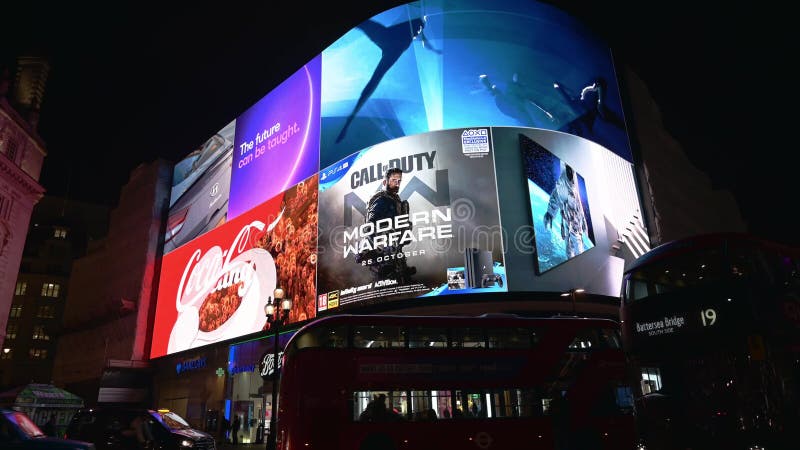 London Buses Passing in Front of the Digital Billboard at Piccadilly ...