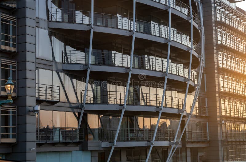 Modern Building with Repeating Structure and Reflected Sky and Clouds ...