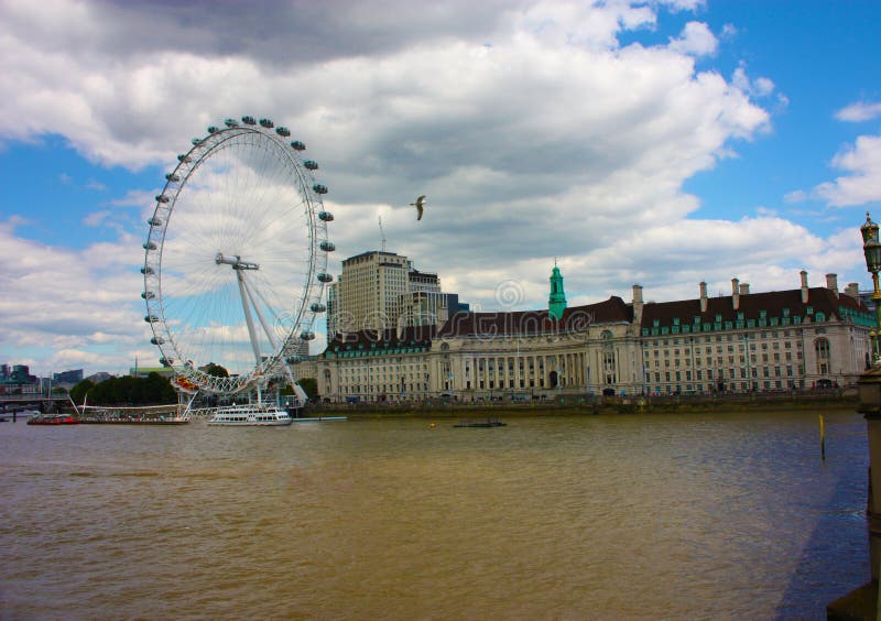 The London Eye on the Thames River on a Slightly Cloudy Spring Day ...