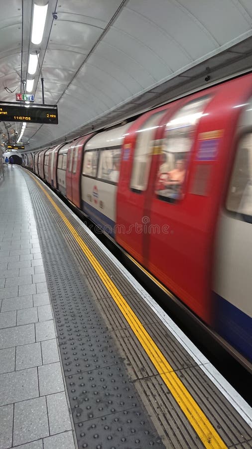London Underground Moving into Train Station Editorial Stock Image ...
