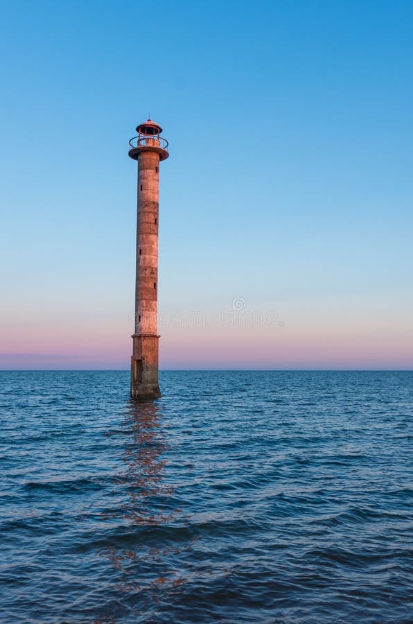 A Lone Lighthouse in Blue Morning Light. Stock Image - Image of ...