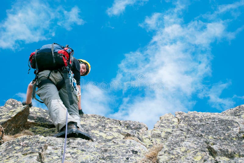 Mountain Climber with Backpack is Sitting on the Stony Ground and ...