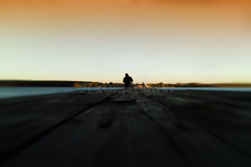 Lone Man on Pier Orange Sunset Zoom Stock Image - Image of sunset ...