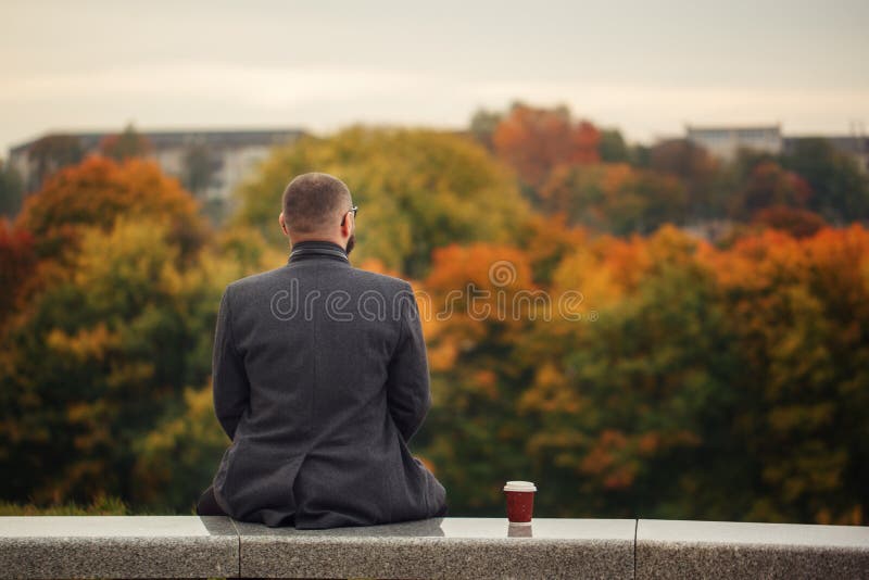 Lone Man Sitting on the Stone Bench and Looking at Nature. Back View ...