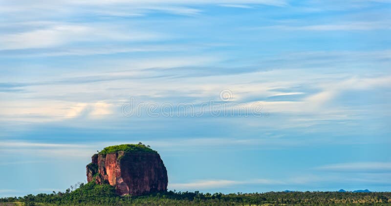 Long Exposure of a Vast Plain with a Towering Rock Formation and Cloudy ...