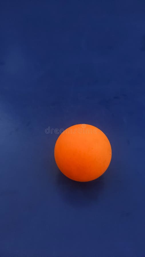 A Lone Orange Ball Sits on a Blue Background Stock Photo - Image of ...