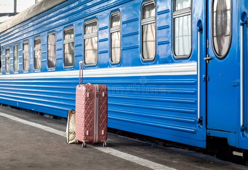 A Lone Suitcase Stands in Front of a Railway Carriage Stock Photo ...