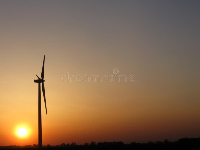 Lone windmill setting sun stock photo. Image of alternative - 181083462