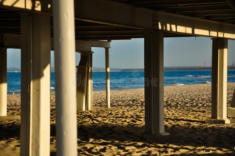 Lonely on the Beach Under the Pier, during the Blue Hour Stock Photo ...