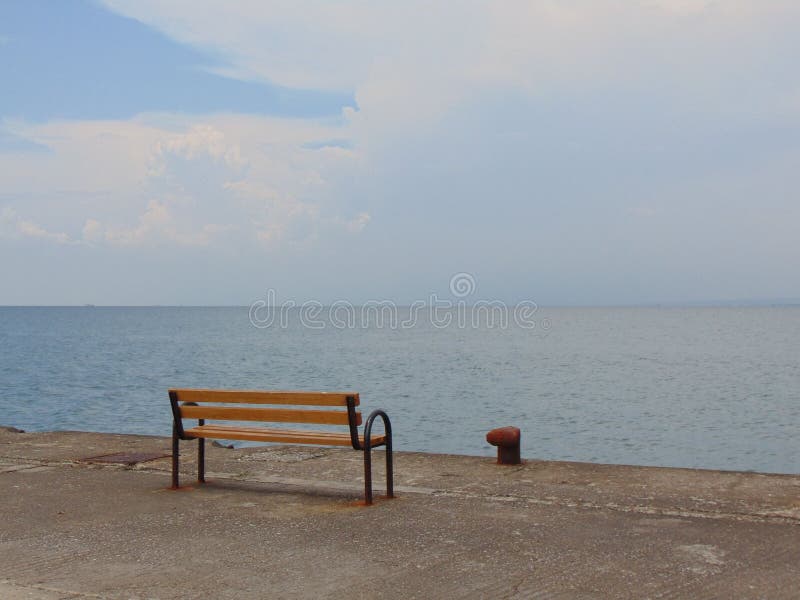 Lonely Bench at the Coast on the Background of the Cloudy Sky Stock ...