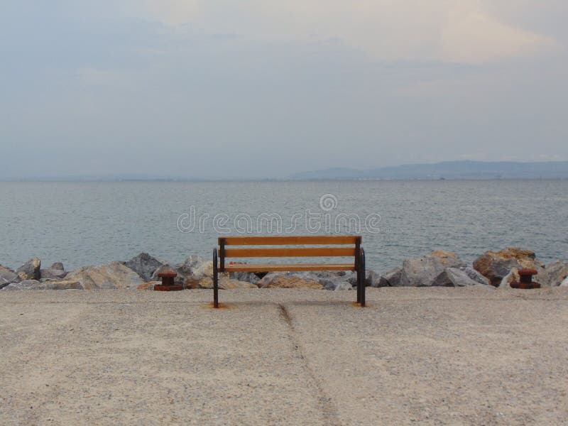 Lonely Bench at the Coast on the Background of the Cloudy Sky Stock ...