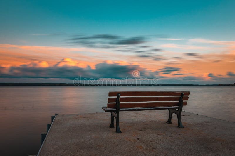 Lonely bench by the lake stock photo. Image of bench - 283874390