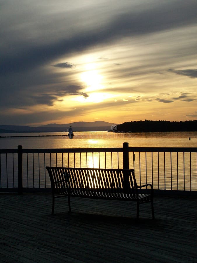 A lonely bench at sunset stock image. Image of sunset - 38665217