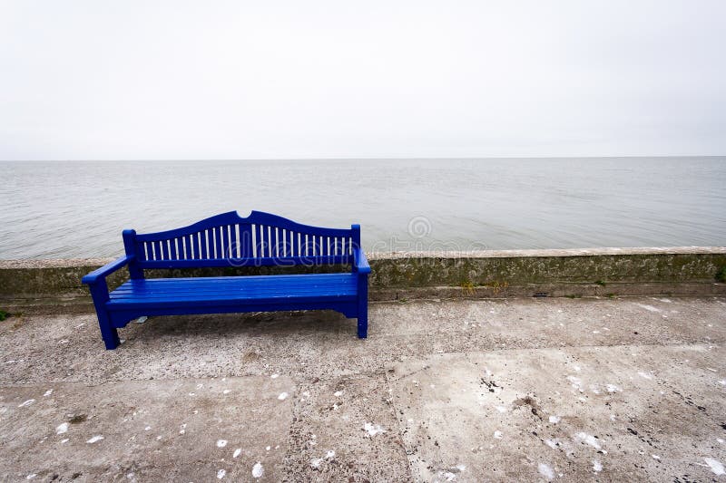 Lonely Blue Bench on a Concrete Pier Under a Cloudy Sky Stock Image ...