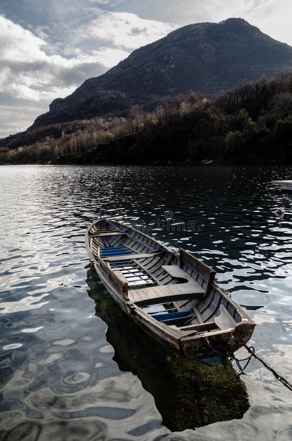 Lonely boat anchored stock image. Image of reflection - 177133619