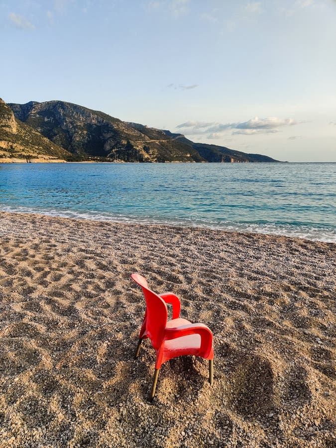 A Lonely Chair Left in the Middle of the Beach on the Coast of the Sea ...