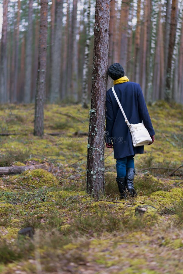 Lonely Girl Stands at the Tree in the Forest. Solitude Stock Image ...