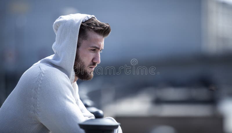 Lonely man with sad look stock photo. Image of city, hooded - 56119522