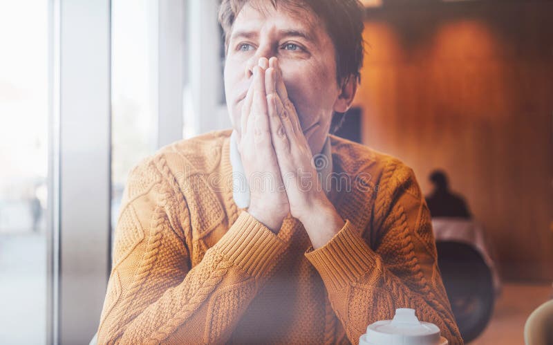 Lonely Man Sitting Inside, Deep in Thought, Hands Pressed Together Near ...