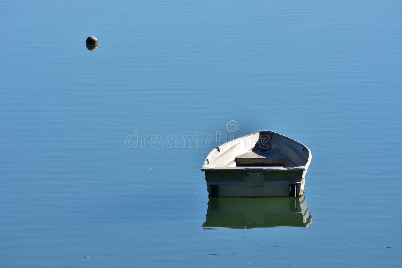 Lonely Metal Dinghy on Calm Water Stock Photo - Image of harbor, blue ...