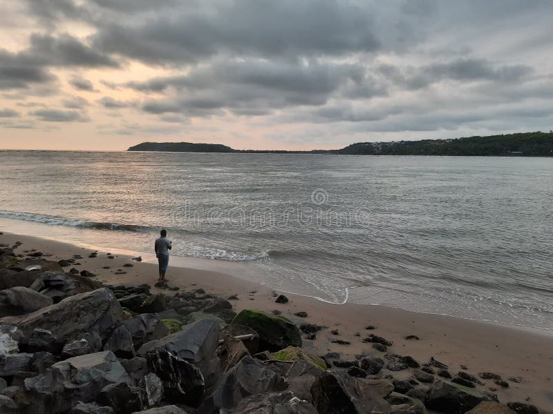 Lonely Person Looking at Sea on a Cloudy Day Stock Photo - Image of ...