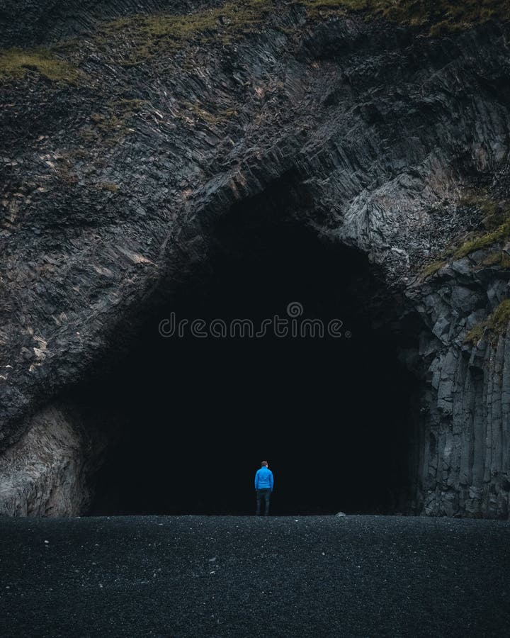 Lonely Person Standing in Front of a Huge Cave Stock Image - Image of ...