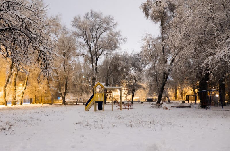 Lonely Playground during the Snowfall Stock Photo - Image of trees ...