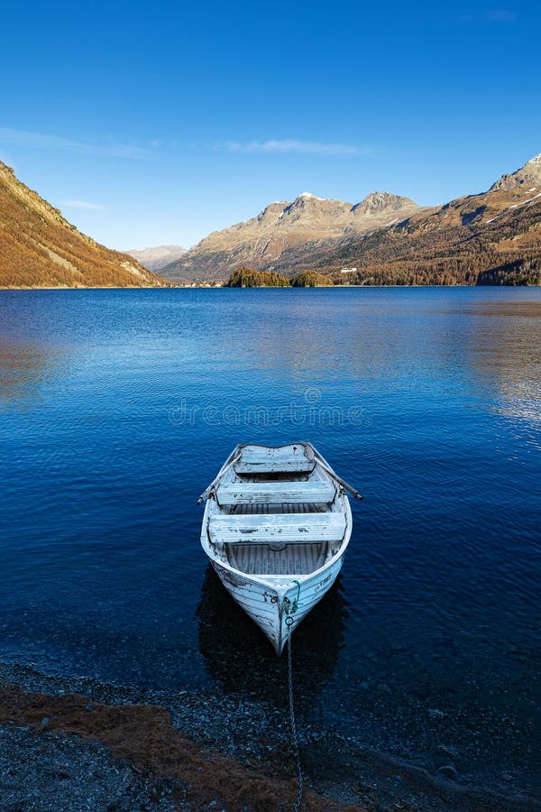 A Lonely Rowing Boat with Docking Chain at the Blue Lake Side Stock ...