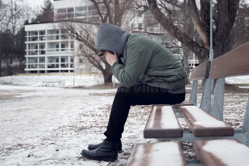 Lonely and Sad Man Sitting on a Park Bench in Snowy Winter Scenery ...