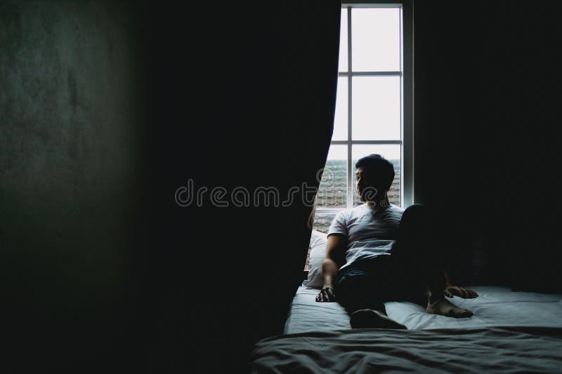 Lonely Single Man Sit and Rest Alone in Dark Bedroom with Light from ...