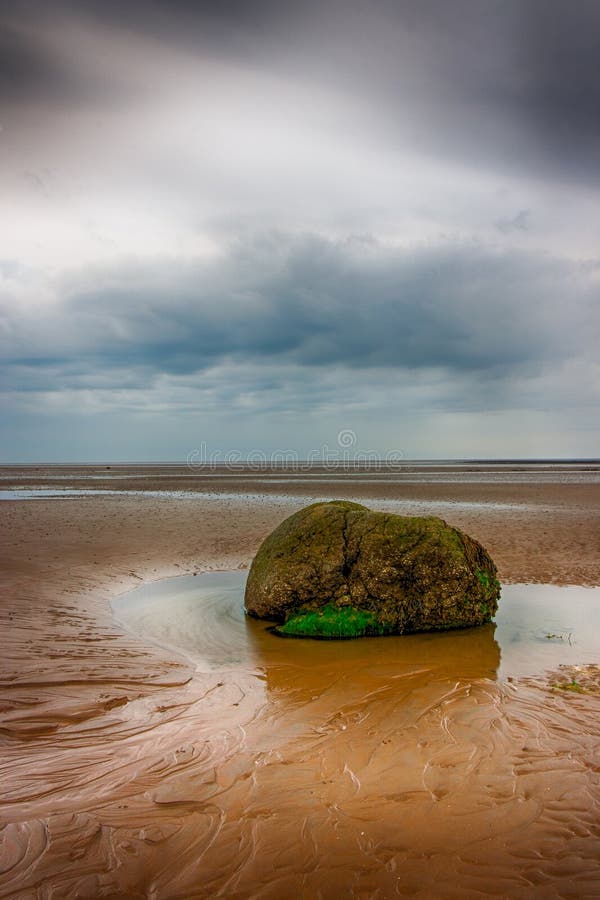 Lonely stone on the beach stock image. Image of sunset - 30884837